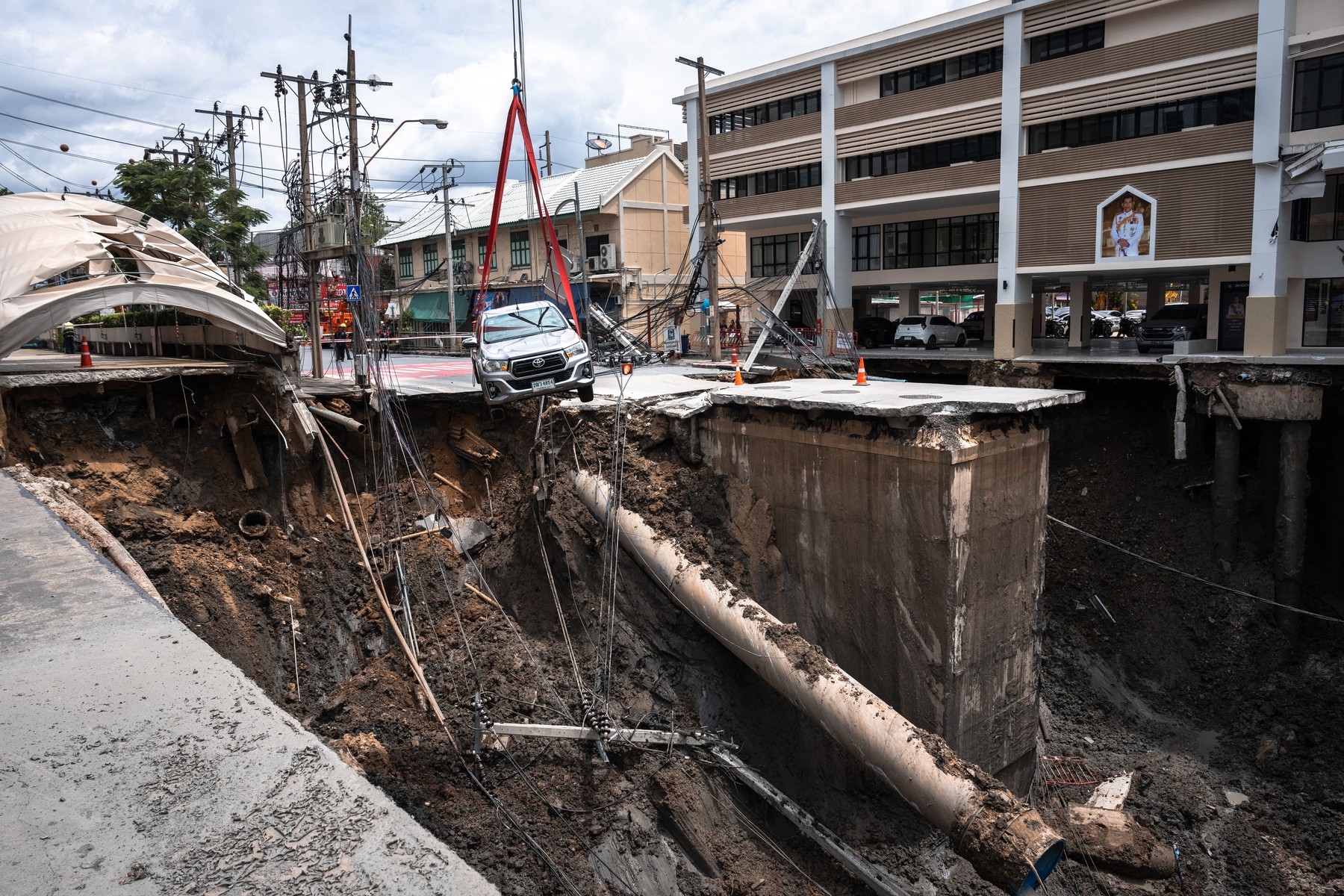 A section of road in Bangkok collapsed over a subway tunnel, forming a ...
